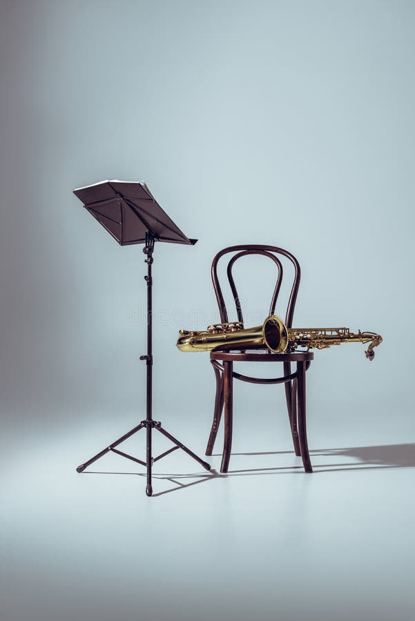 Music Stand for Notes and Professional Saxophone on Chair Stock Image ...