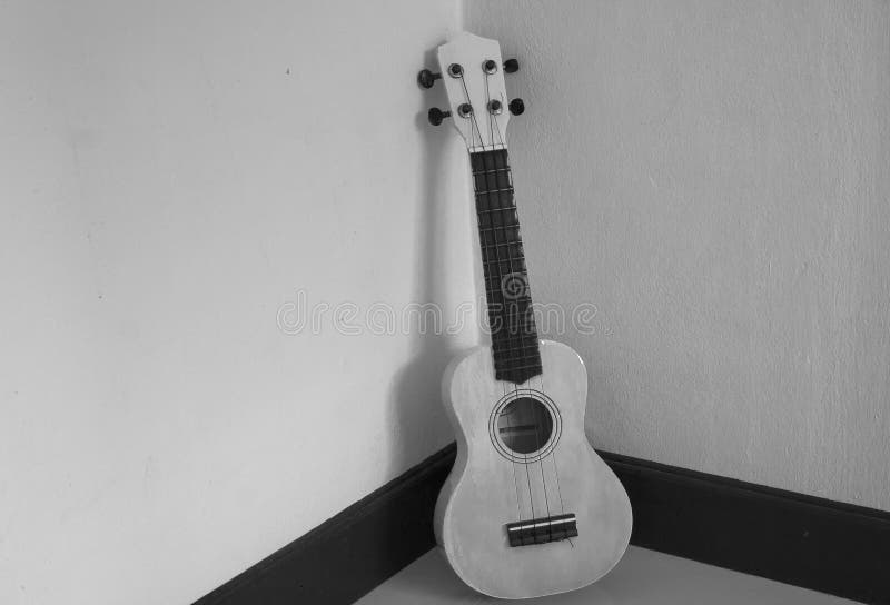Musical Instrument Ukulele Guitar on Gray Tile Floor at Room Corner ...