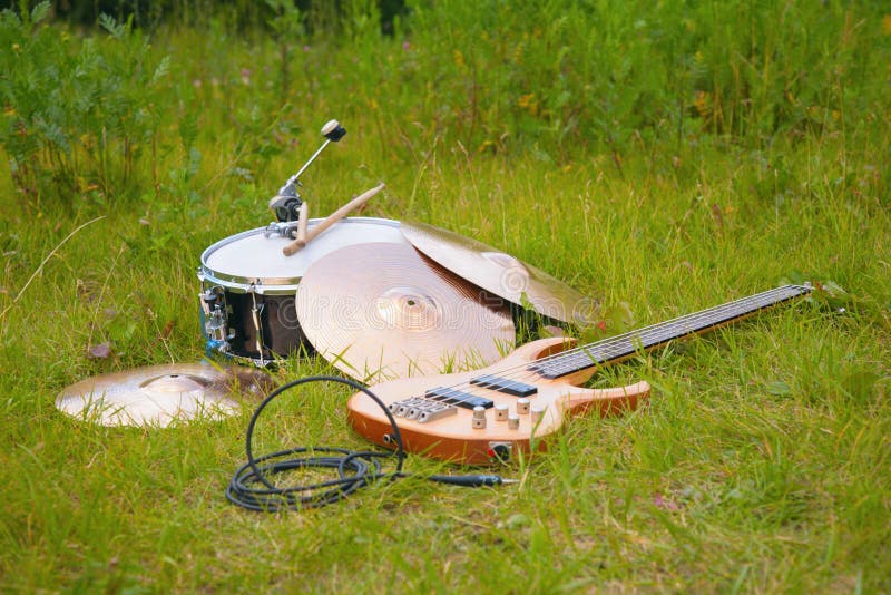 Musical Instruments, Guitar, Drum, Plates on Grass Stock Image - Image ...