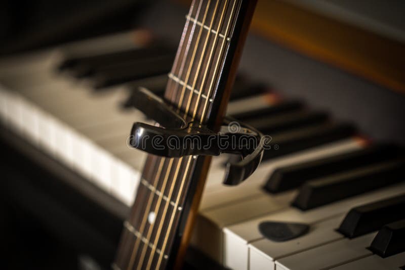 Musical Instruments Piano Keys and Acoustic Guitar Capadaster Stock ...