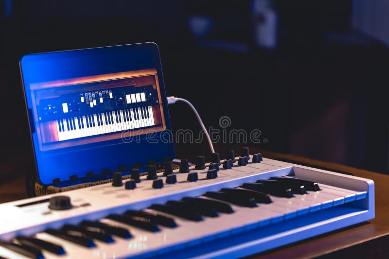Musical Keyboard and Tablet in a Dark Room, Music Production. Stock ...