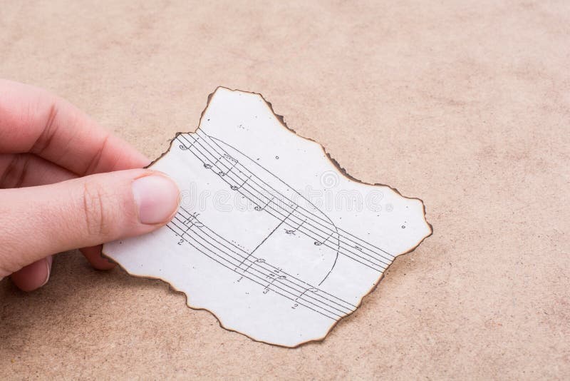 Musical Notes on Burnt Paper in Hand Stock Photo - Image of song, music ...