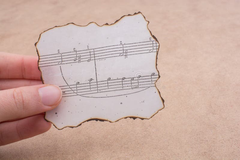 Musical Notes on Burnt Paper in Hand Stock Photo - Image of song, note ...