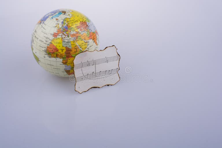 Musical Notes on a Burnt Paper and a Model Globe Stock Image - Image of ...