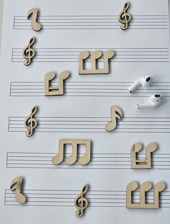 Musical Notes and Earphones Arranged on Sheet Music for a Creative and ...