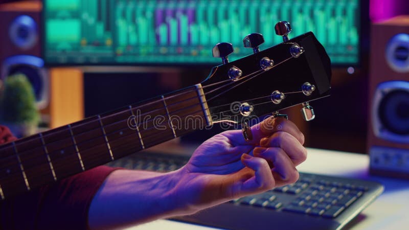 Musical Performer Tuning His Guitar by Twisting the Knobs Stock Video ...