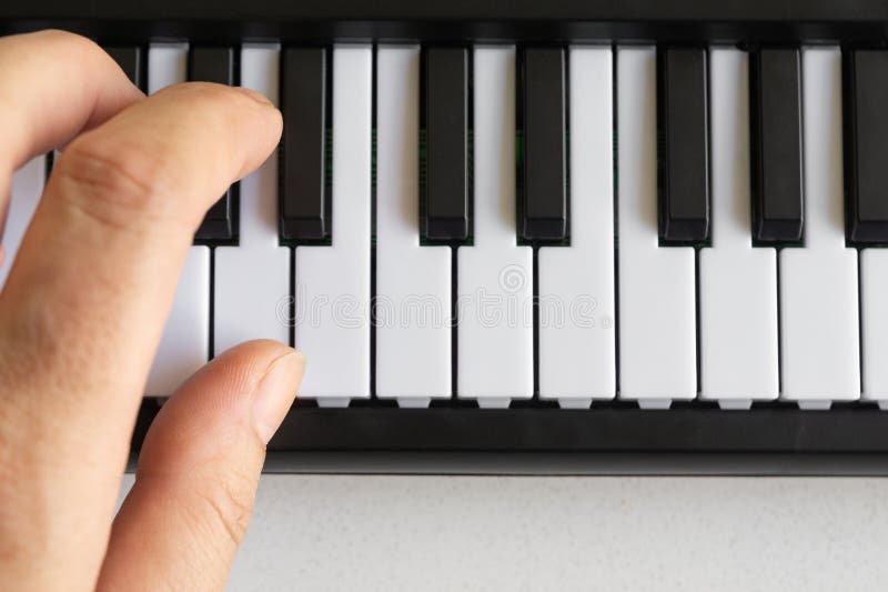 Musician Hand Playing a Melody on a Small Keyboard, Front View Stock ...