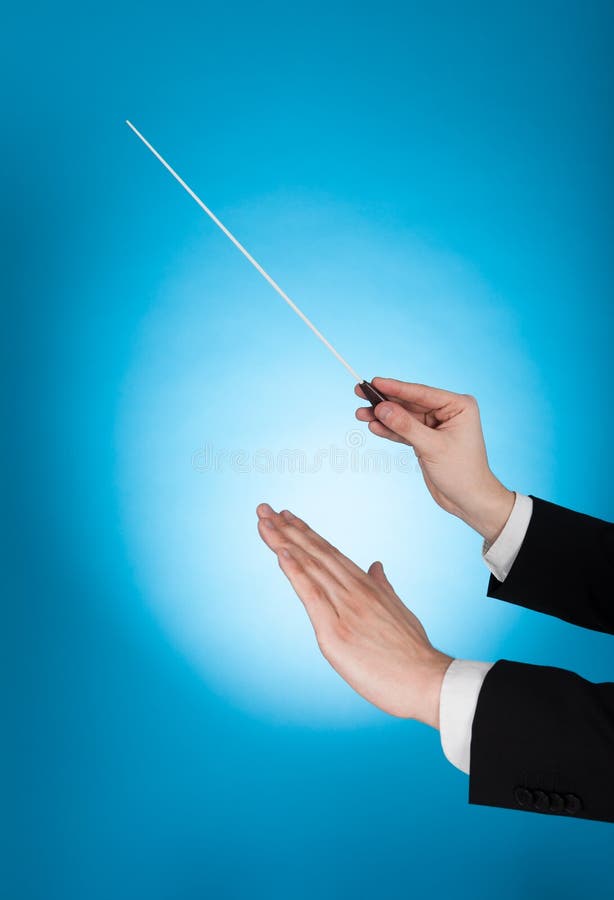 Musician Holding Baton Against Blue Background Stock Image - Image of ...