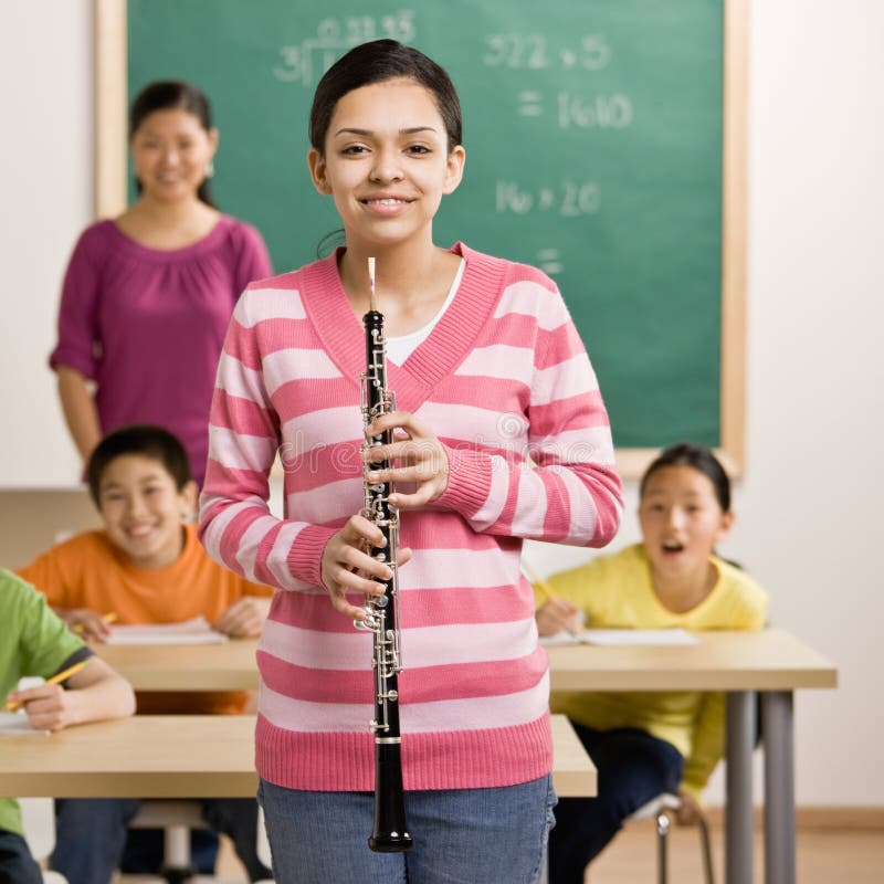 Musician Holds Clarinet in School Classroom Stock Photo - Image of ...