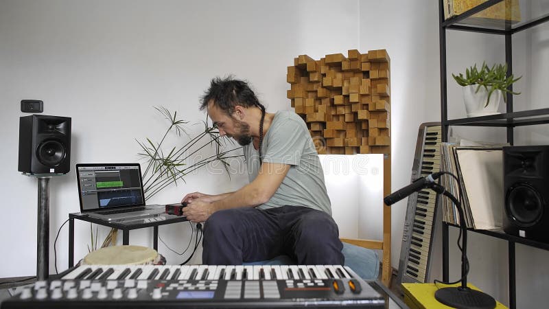 Musician in Home Music Studio Plugging Microphone in and Testing. Stock ...