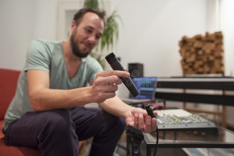 Musician in Home Music Studio Plugging Microphone in and Testing Stock ...