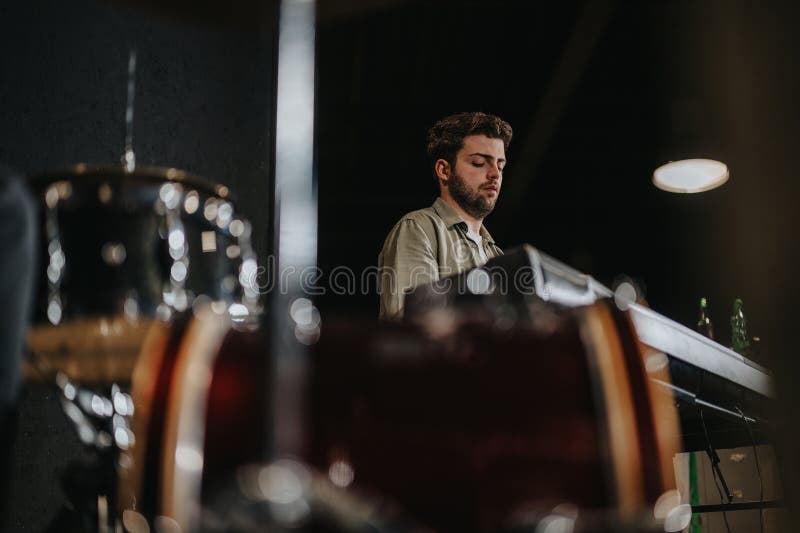 Musician Playing Keyboard on Stage with Focus on Drum Set Foreground ...