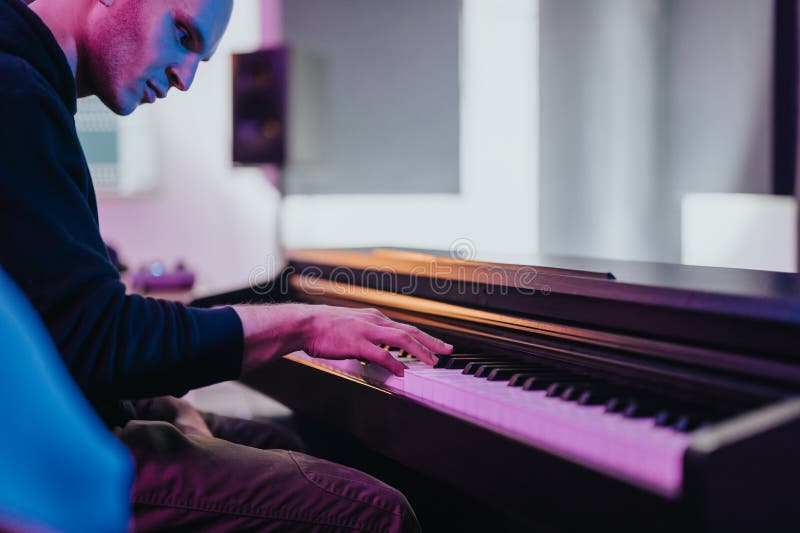 Musician Intensely Playing Piano in a Modern Music Studio Environment ...