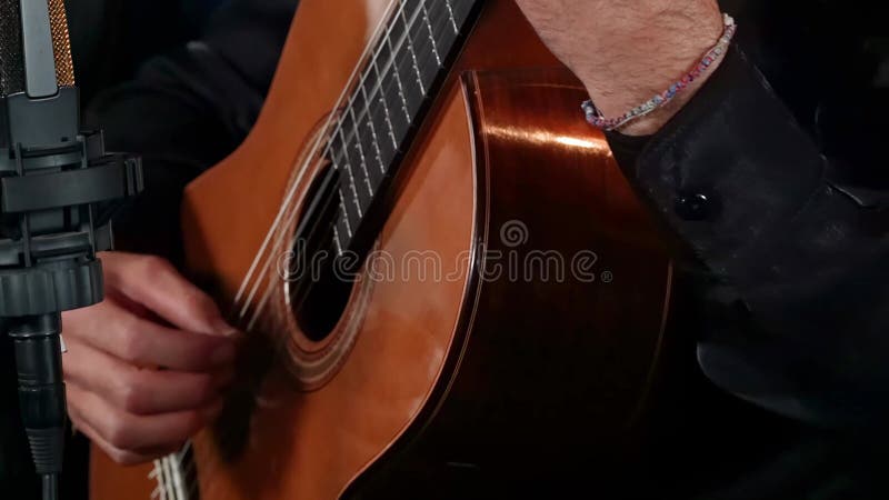 Musician Playing Classical Guitar with Microphone for Recording Session ...