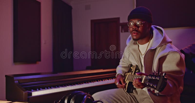 Musician Playing Guitar and Singing in Recording Studio: Creative ...