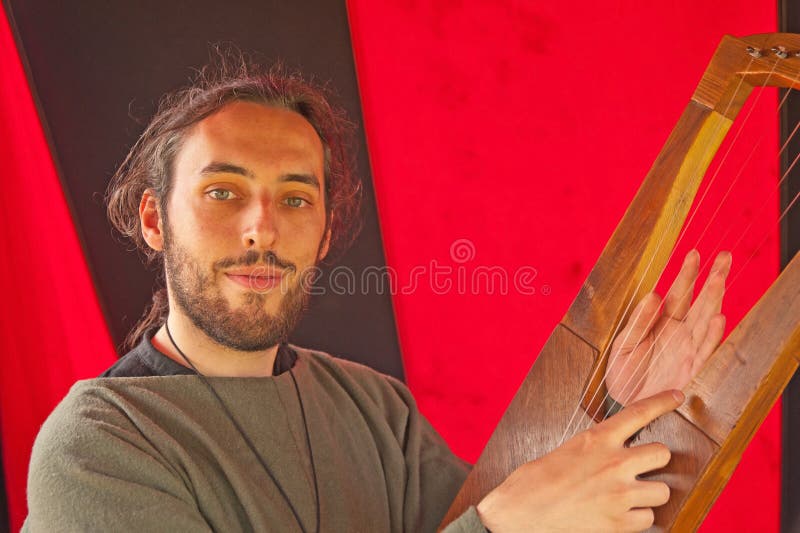 Musician playing lyre editorial stock image. Image of frame - 32873534