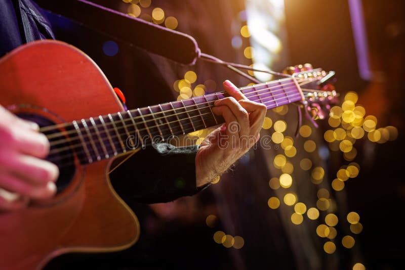 A Musician Plays a Chord on an Acoustic Guitar during a Performance ...