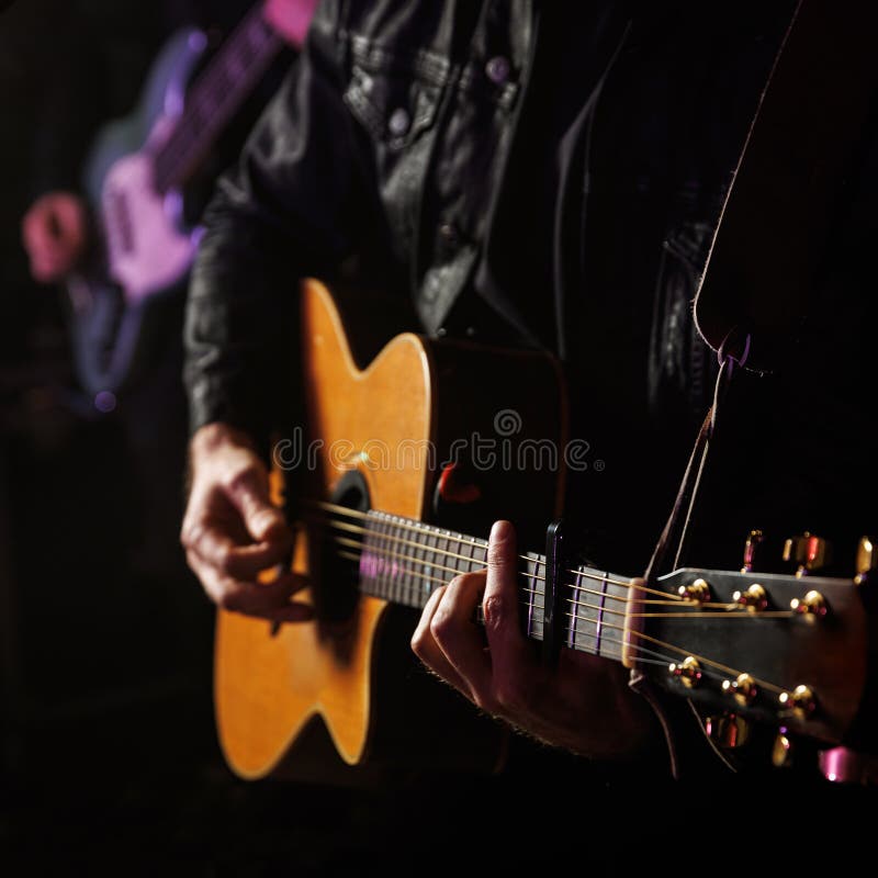 A Musician Plays a Chord on an Acoustic Guitar during a Performance ...