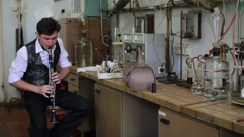 Musician Plays the Flute in a Chemistry Lab Stock Video - Video of ...