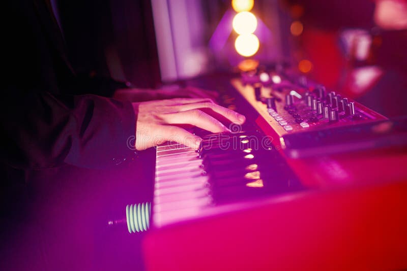 A Musician Plays Modern Piano Keyboards during a Concert Performance ...