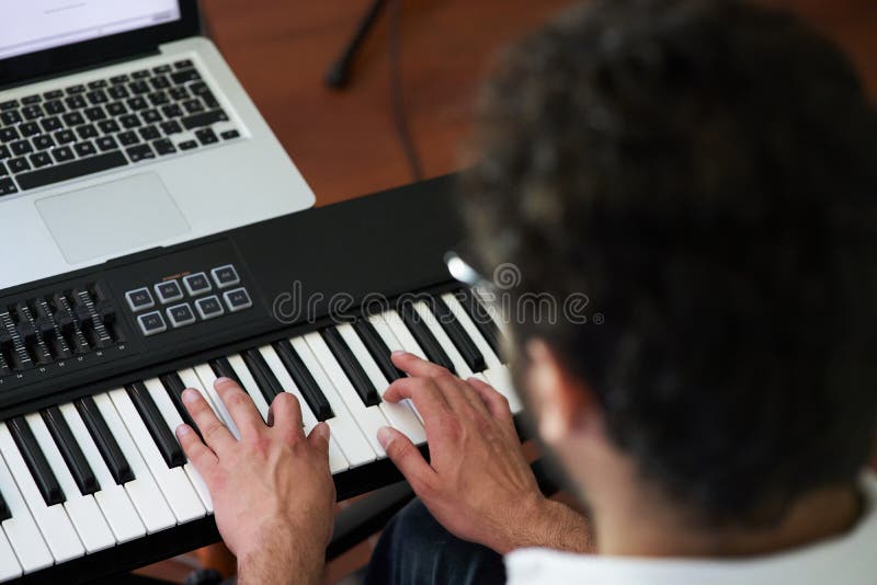 Musician Plays Piano in Front of His Computer Stock Photo - Image of ...
