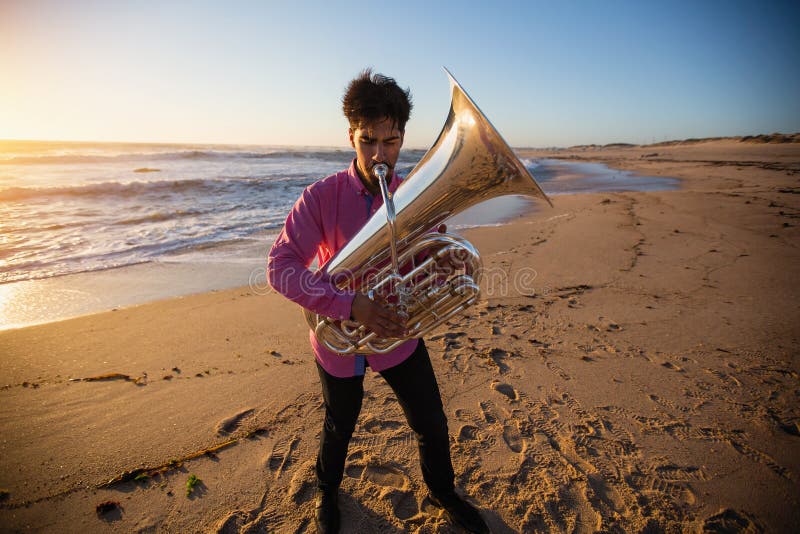 Musician Plays a Wind Instrument Standing on the Ocean Coast. Hobby ...