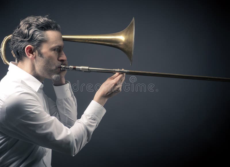 Musician with a trombone stock image. Image of used, trombone - 85359611