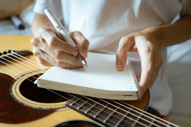 Musician Using Pen and Notebook To Write a Song Stock Photo - Image of ...