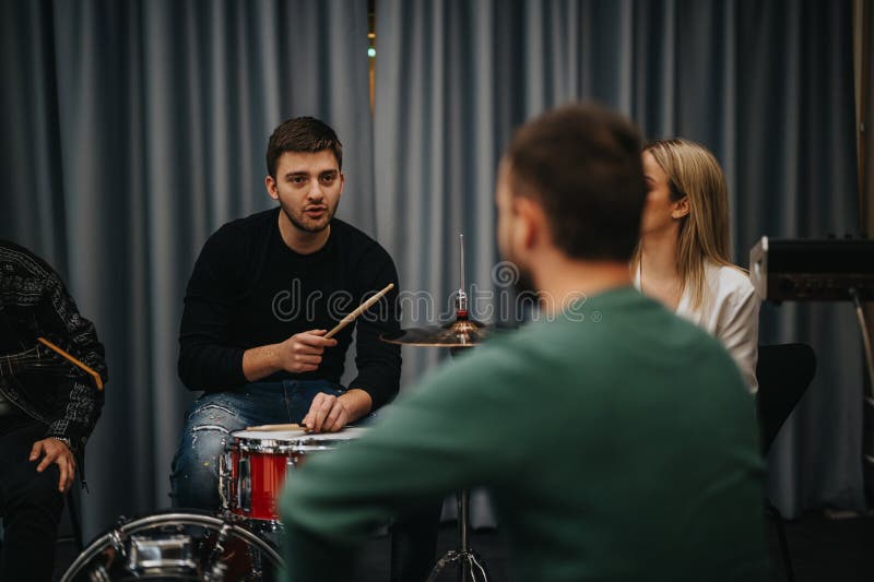 Group of Musicians Rehearsing in a Studio Setting with Musical ...