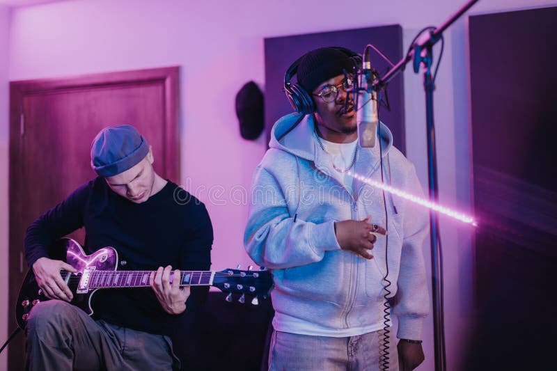 Musicians Recording in a Professional Studio with Guitar and Microphone ...
