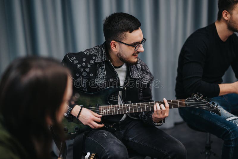 Musicians Rehearsing with Guitars in a Studio Preparing for a Live ...