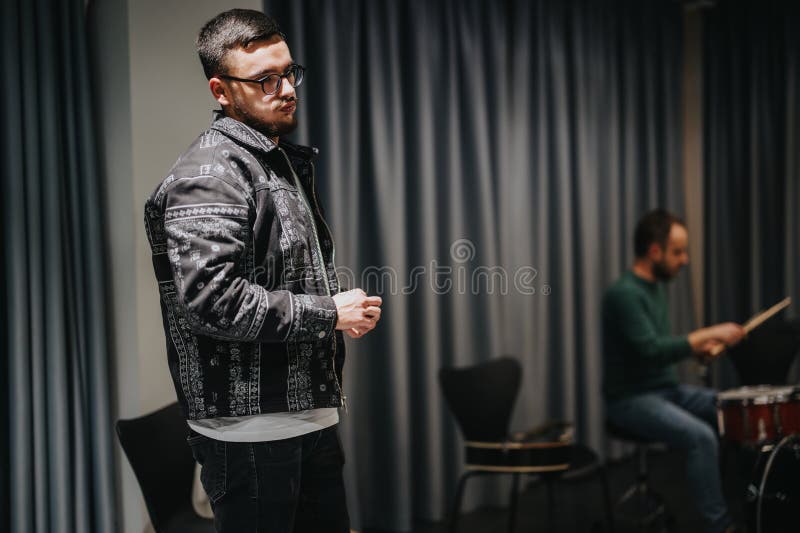 Musicians Rehearsing in a Studio Space, Preparing for a Musical ...