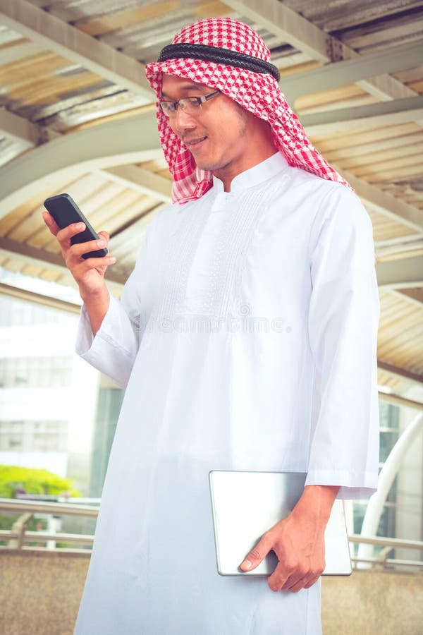 Muslim Arab Man Play Smart Phone and Talking on the Phone with Walking ...