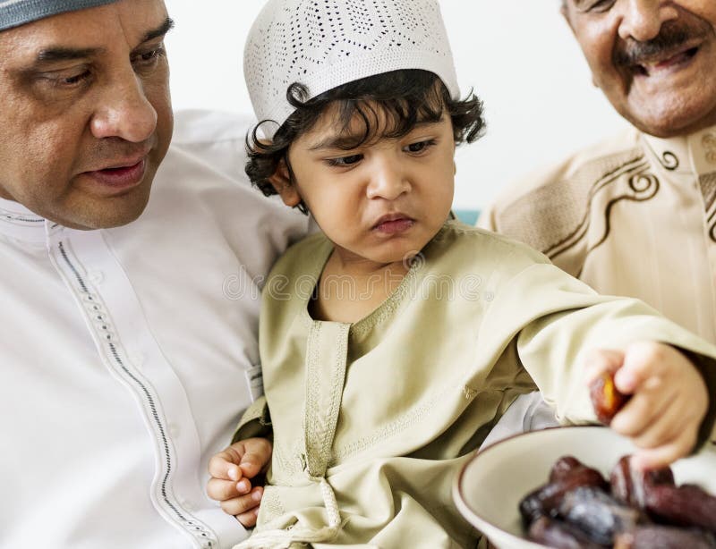 Muslim Boy Eating Dried Dates Stock Photo - Image of modest, parents ...
