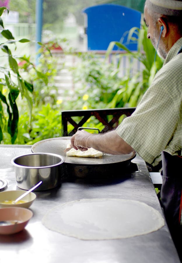 Muslim guy cooking a roti editorial stock image. Image of halal - 33108784