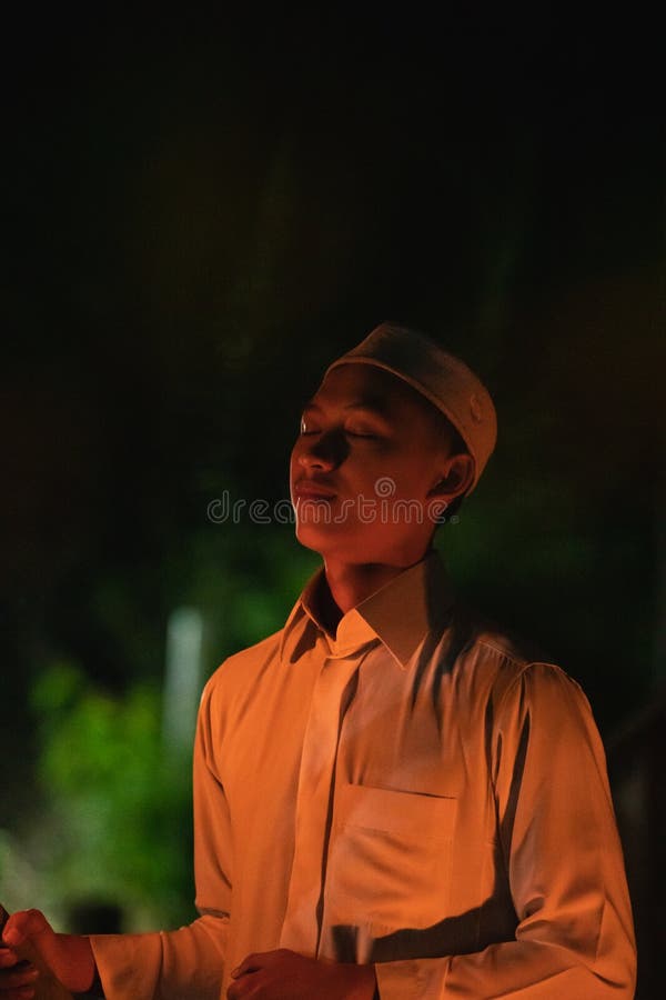 A Muslim Man Lighten Up the Campsite with the Fire Torch in His Hands ...