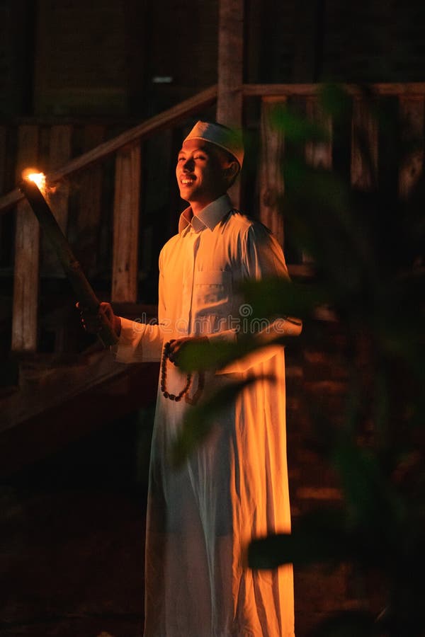 A Muslim Man Standing with the Fire Torch in Her Hand at the Front of ...