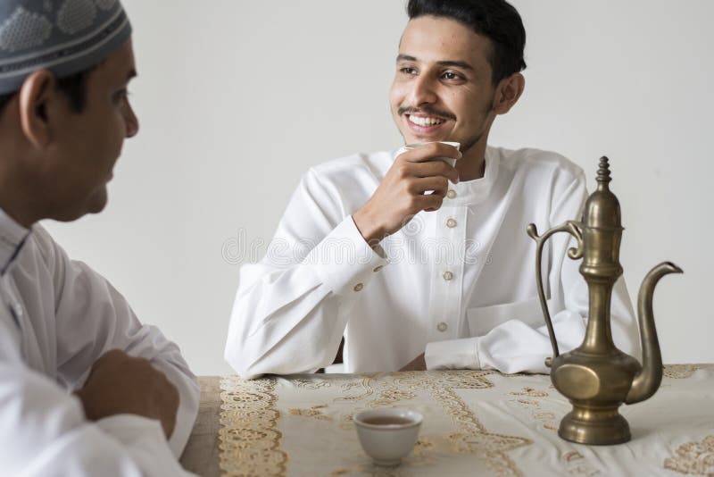 Muslim Men Having a Cup of Tea Stock Photo - Image of clothing, kufi ...