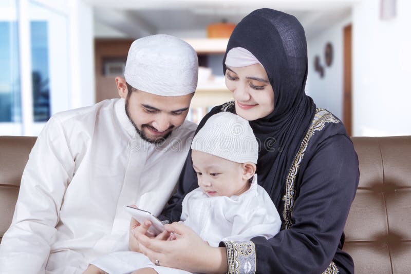 Muslim Parents and Child Using Cellphone Stock Image - Image of father ...