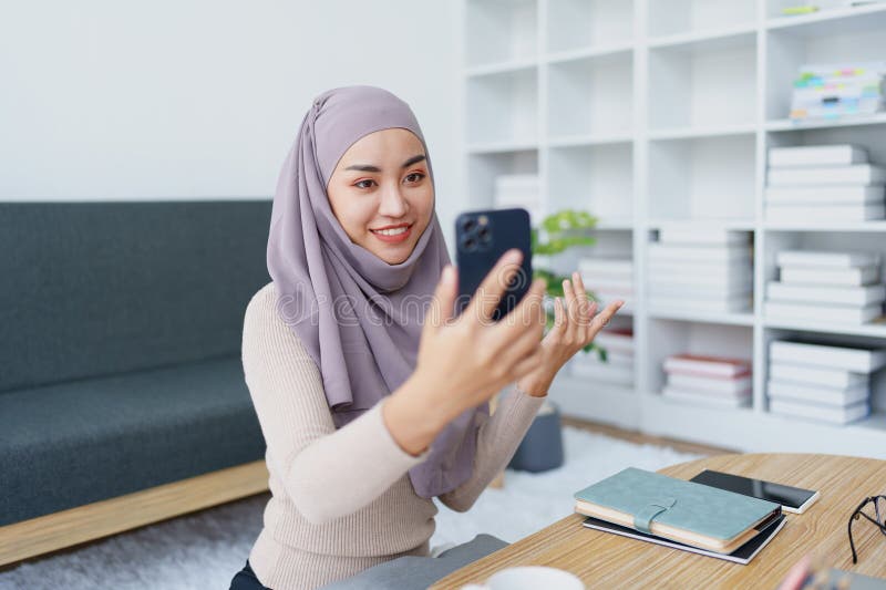 Muslim Undergraduate Student Using Mobile Phone To Contact Friends ...