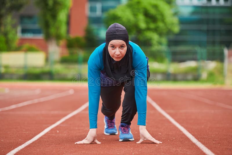 Muslim Woman in Burqa in Sporty Muslim Clothes in Starting Pose for ... Muslim Woman in Burqa in Sporty Muslim Clothes in Starting Pose for ...