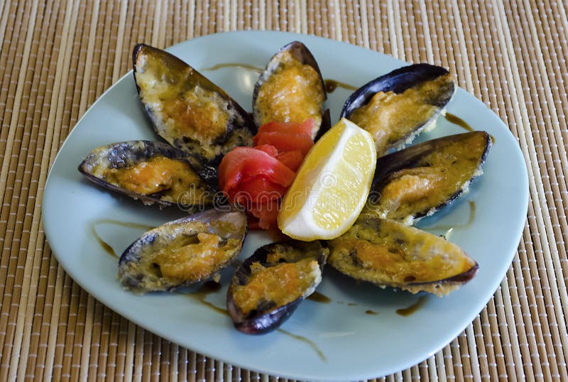 Mussels baked with cheese stock photo. Image of dish - 178672878