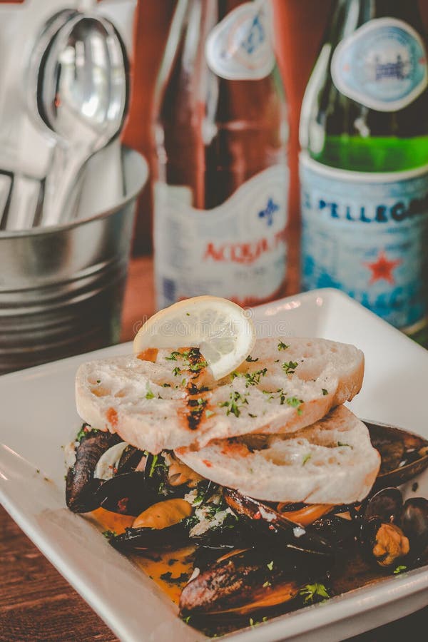 Mussels Saute in White Wine Sauce and Garlic and Served with Garlic ...