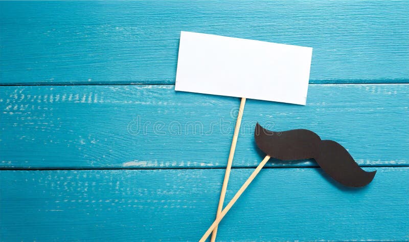Mustache and Blank Sign Prop on Blue Painted Wooden Table Stock ...