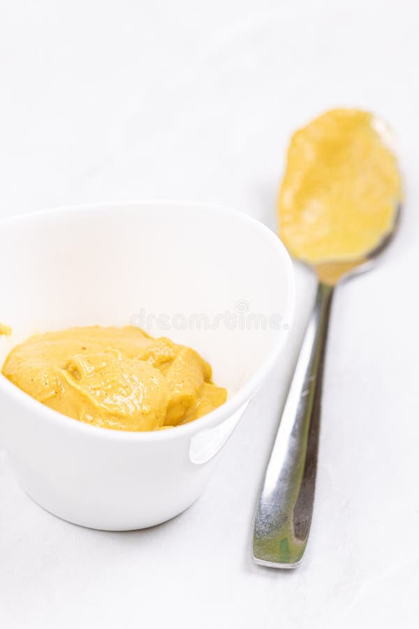 Mustard on the Metal Spoon Above White Background Stock Image - Image ...
