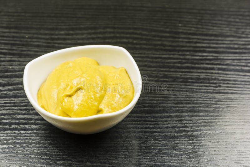 Mustard in a bowl. stock photo. Image of flavoring, dinner - 107674130