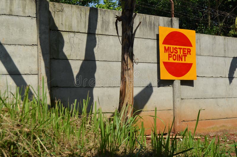 Muster Point Sign Against a Concrete Fence Stock Photo - Image of ...