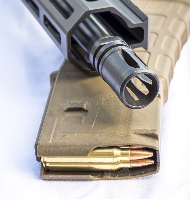 The Muzzle and Barrel of an AR 15 Rifle on Top of a Rifle Magazine ...