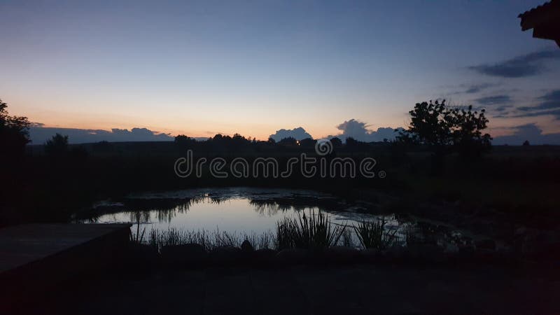 Pond in the evening stock photo. Image of dawn, peer - 222810040