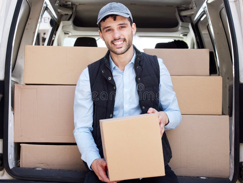 On My Way To Drop-off the Next Box. Portrait of a Young Delivery Man ...